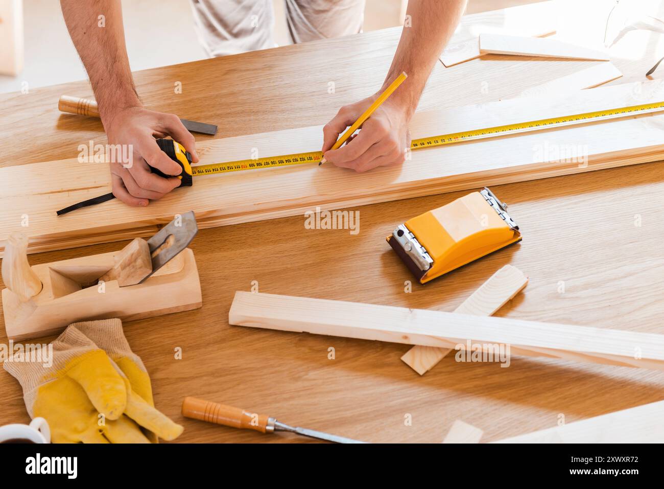 Tools of his trade. Close-up of young male carpenter making ...