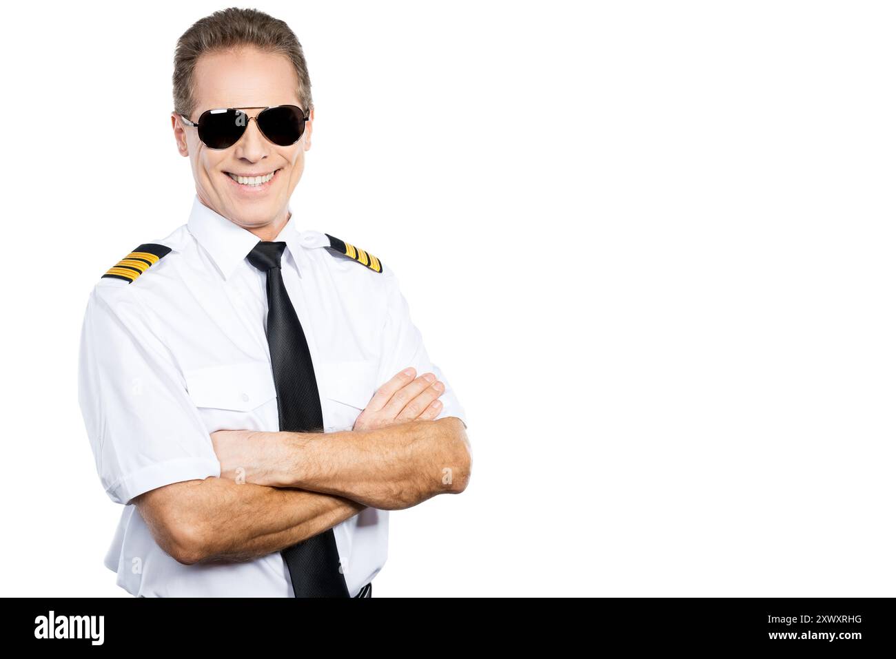 Confident pilot. Confident male pilot in uniform keeping arms crossed ...