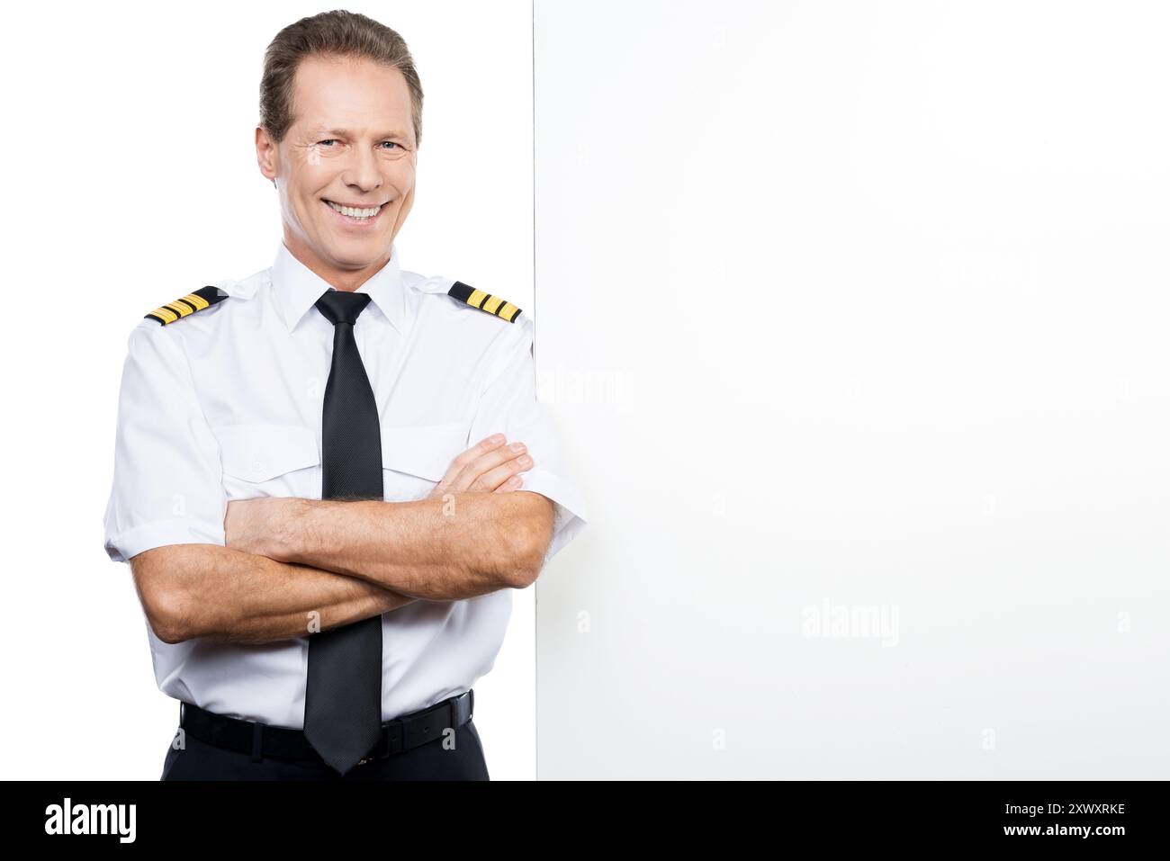 Confident and experienced pilot. Confident male pilot in uniform ...