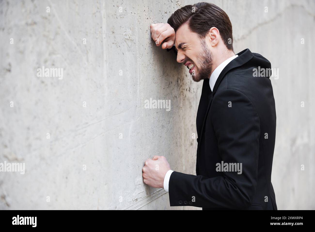 Depressed businessman. Side view of depressed young man in shirt and ...