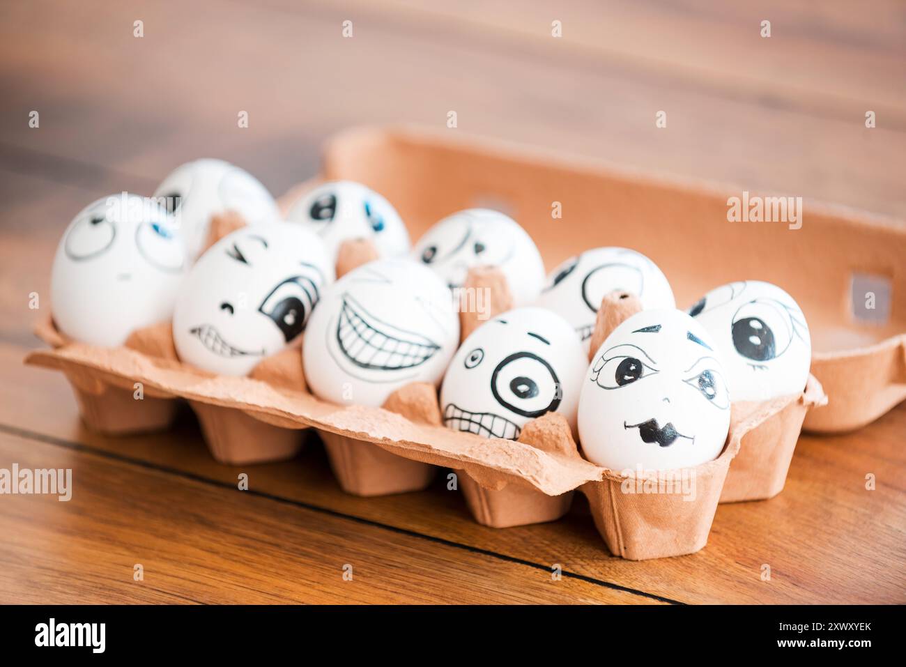 Funny eggs. Close-up of funny eggs with different emotions laying in ...