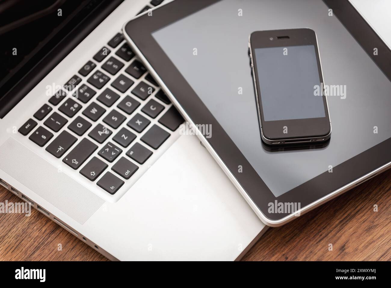 Smart helpers for good business. Close-up of laptop with digital tablet ...