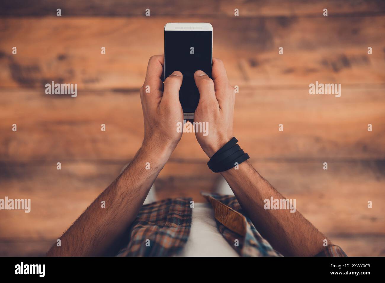 Staying in touch. Top view of man holding smart phone while standing on ...