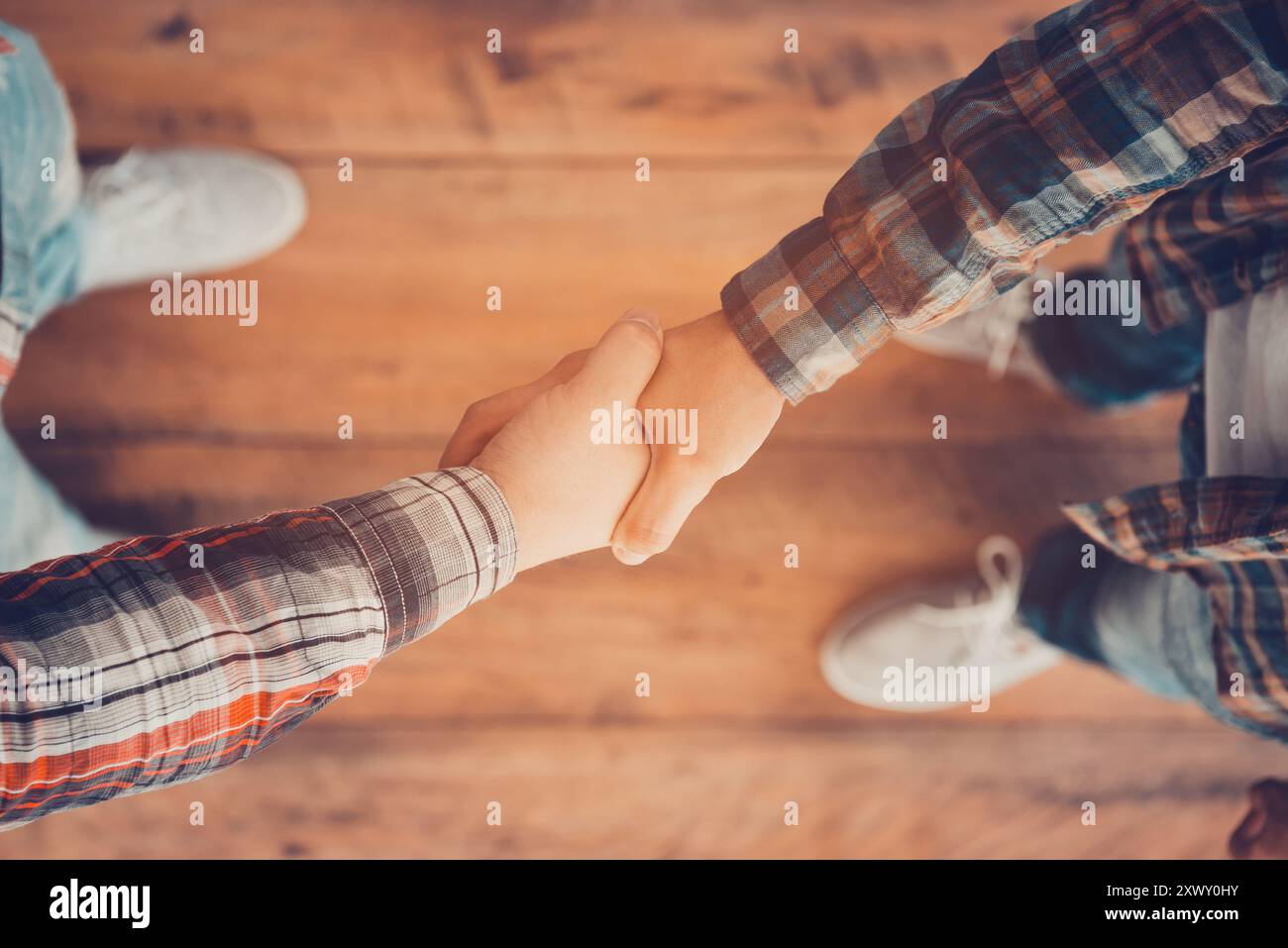 Men shaking hands. Top view of two men shaking hands while standing on ...