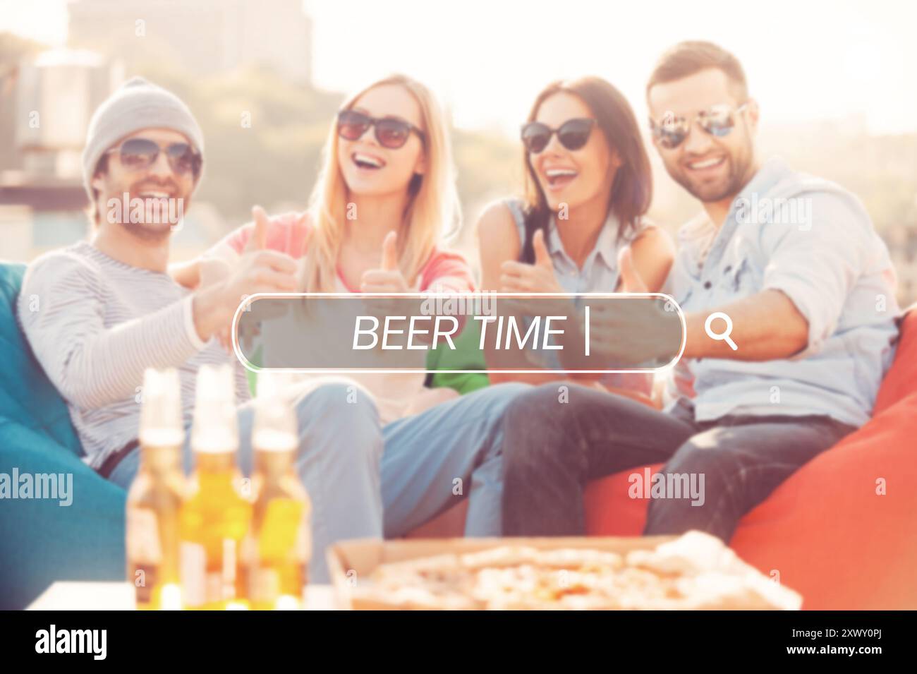 Beer time. Four young cheerful people showing their thumbs up and ...