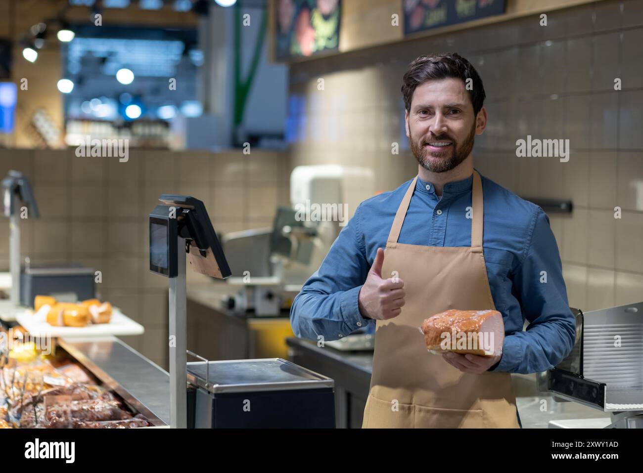 Cheerful grocery store employee gives thumbs up while holding piece of ...