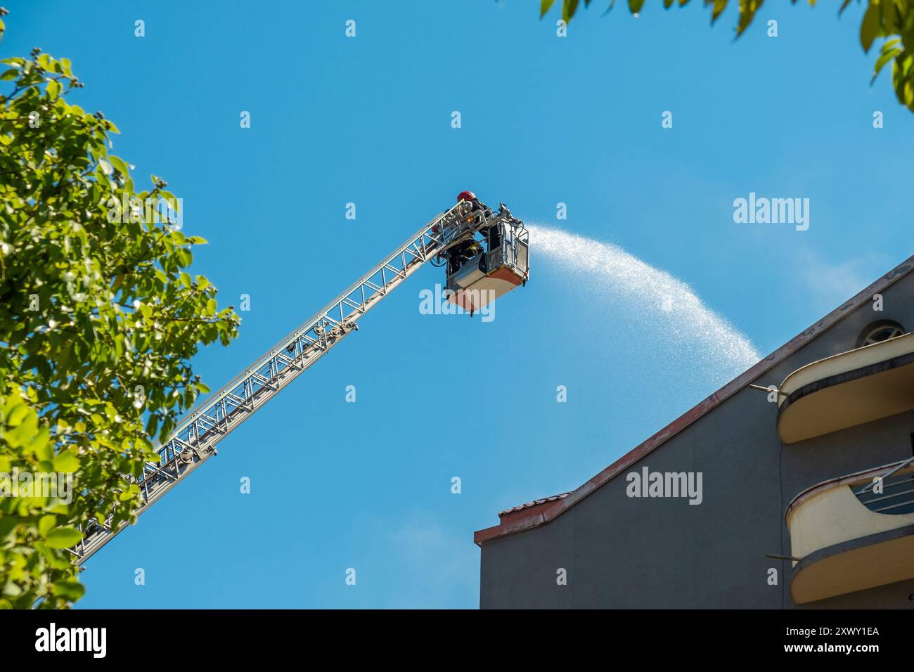Firefighters in elevated platform extinguish burning house using ...