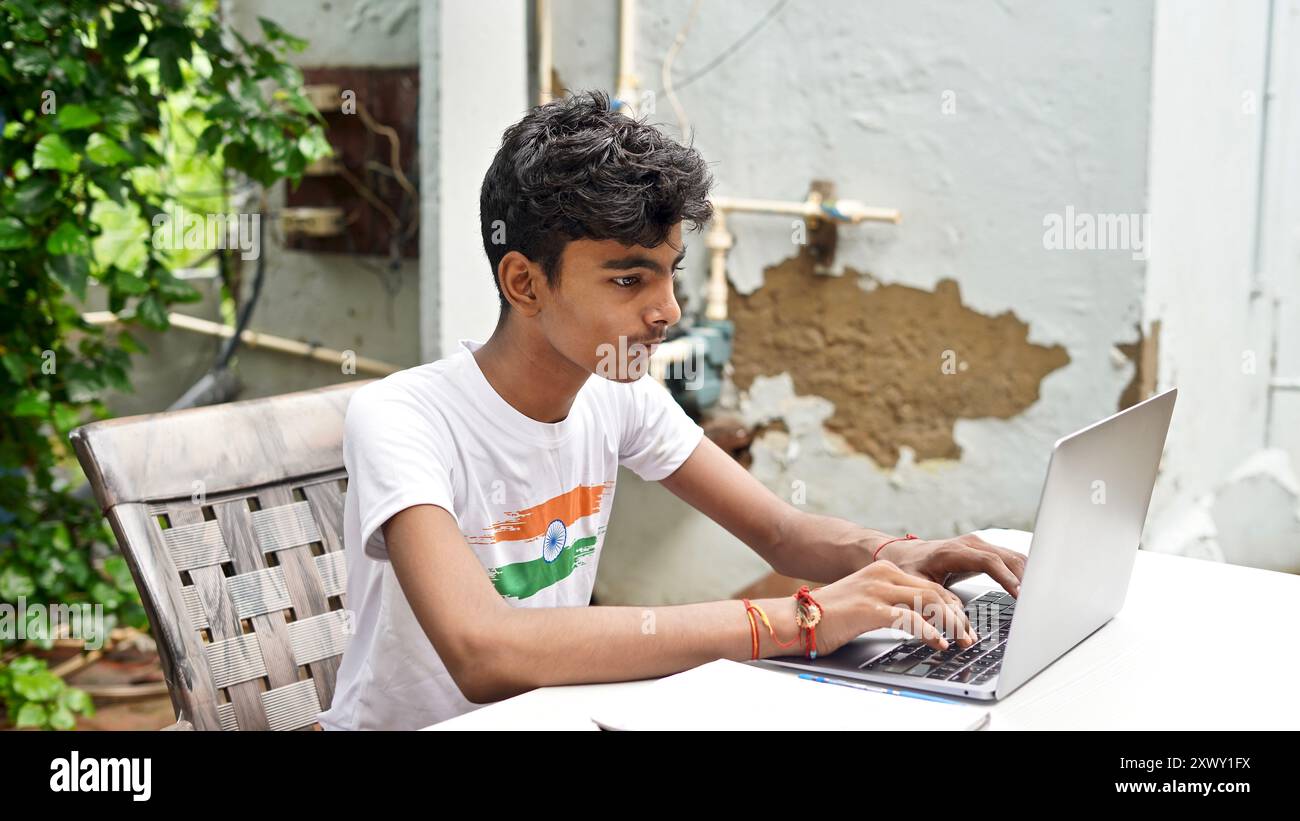 Indian village students learning online with laptop and doing homework ...