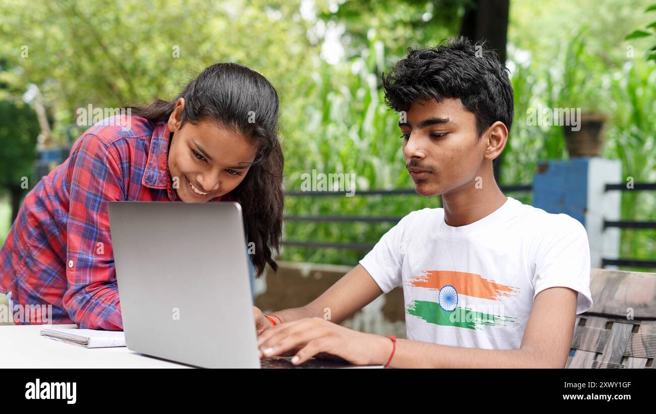 Indian village students learning online with laptop and doing homework ...