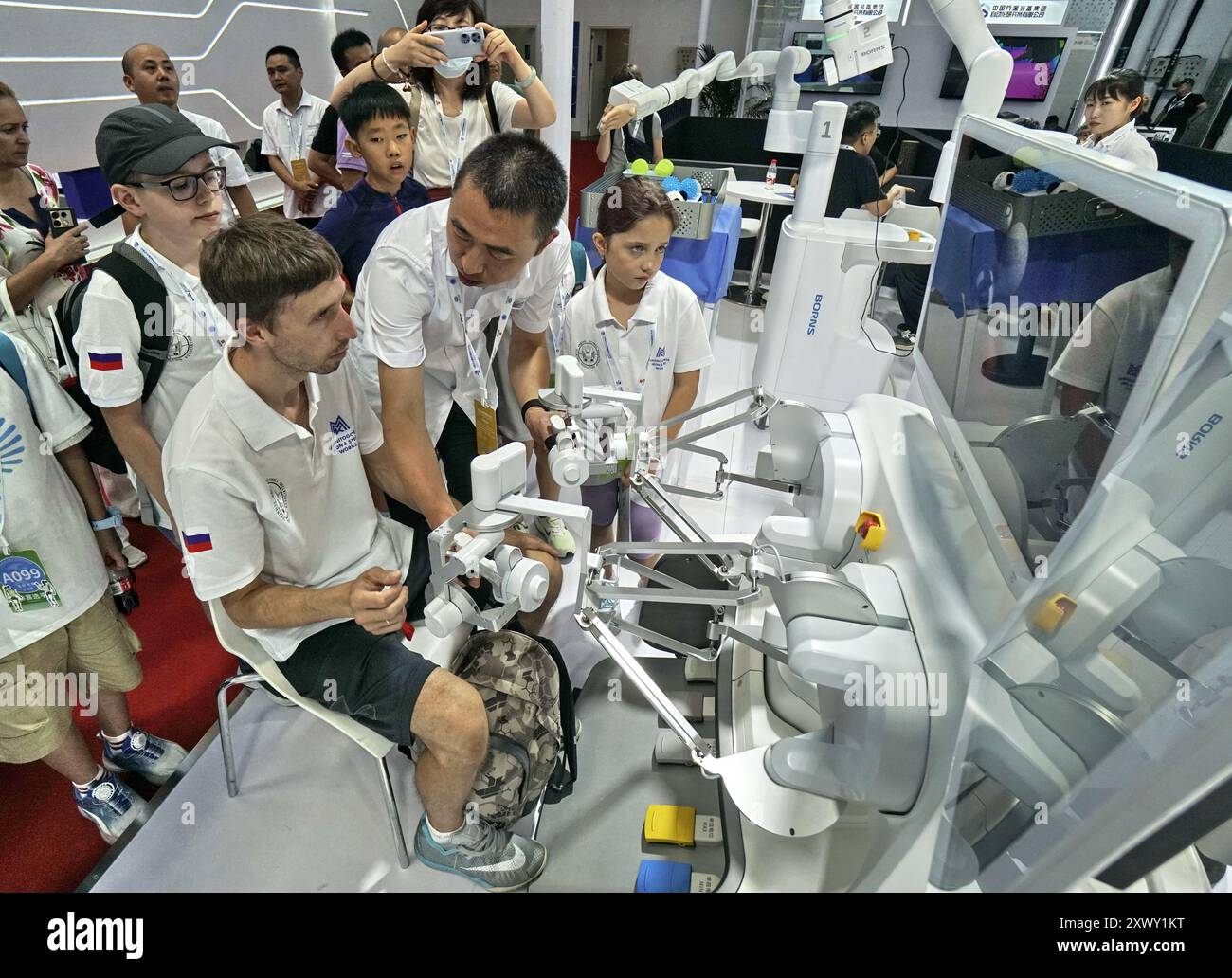 Beijing, China. 21st Aug, 2024. A visitor interacts with a medical ...