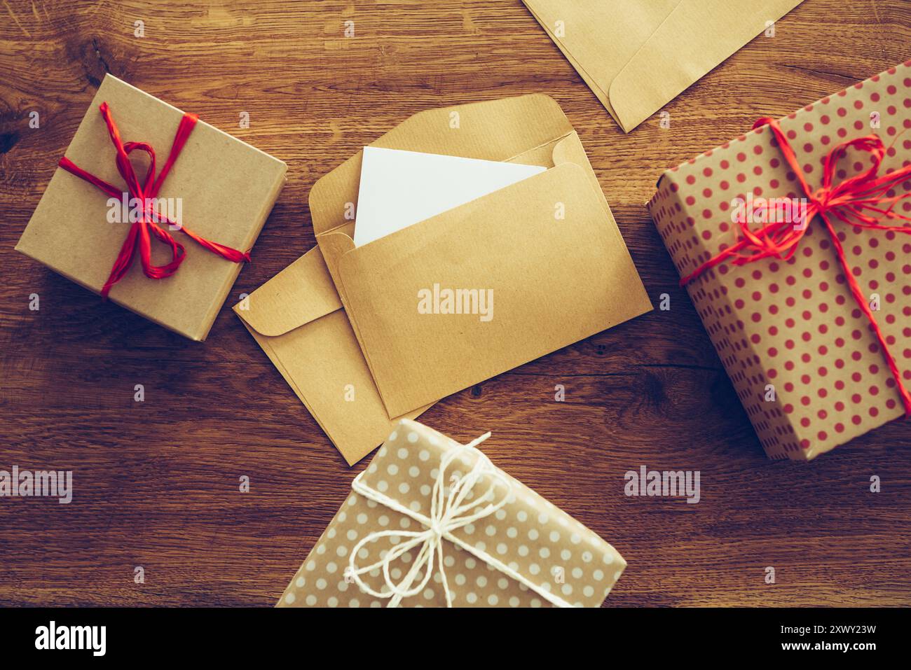 Invitations for party. Close-up top view of gift boxes and opened ...