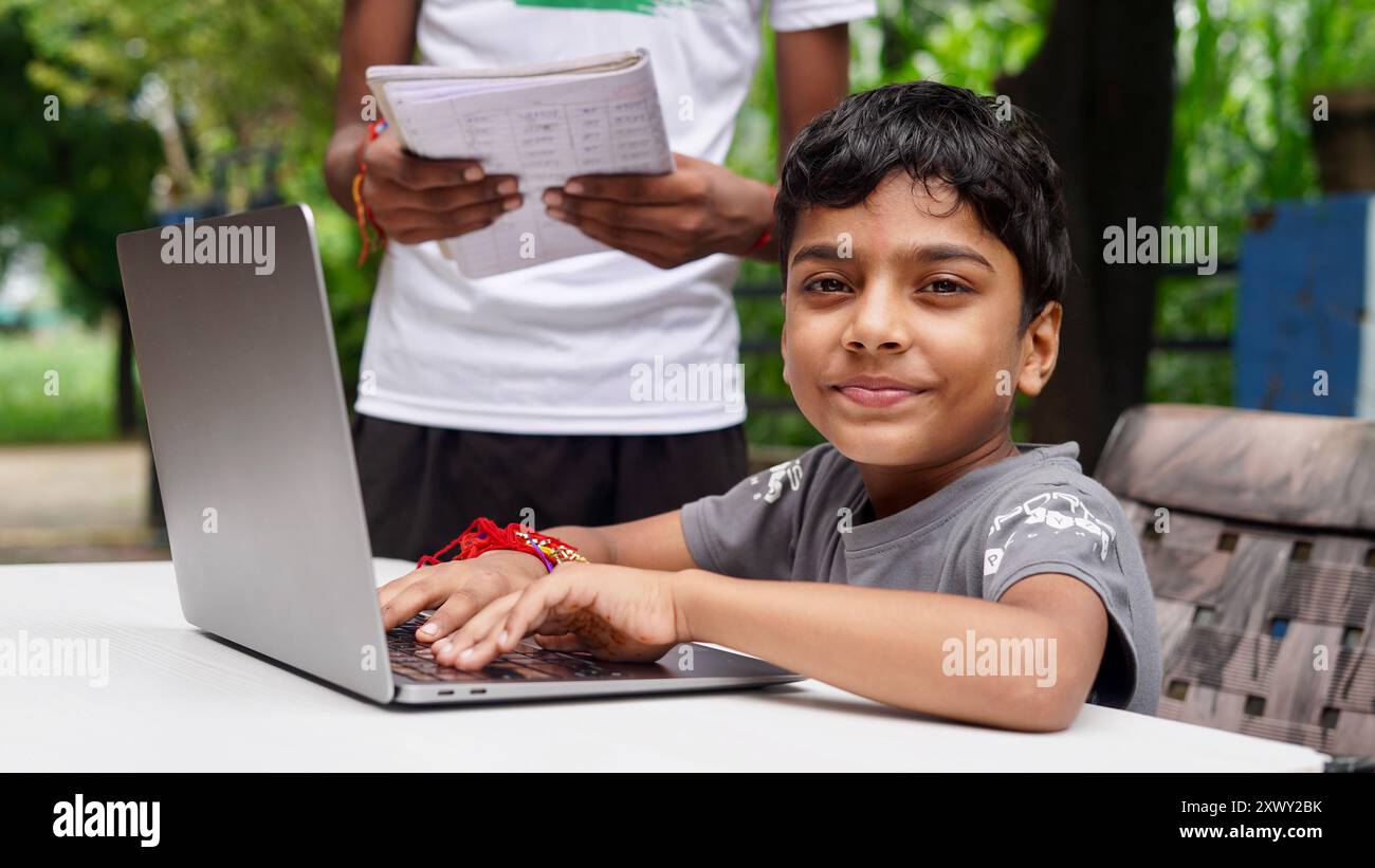 Indian village students learning online with laptop and doing homework ...