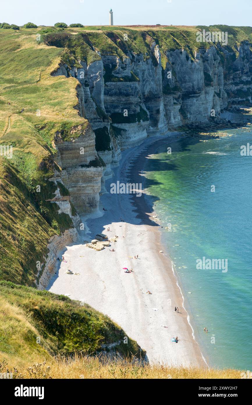 Plage du Tilleul beach near Etretat with Phare d'Antifer lighthouse in ...
