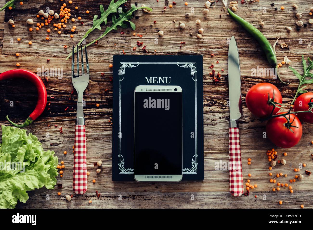 Call for food. Top view of chalkboard menu with smart phone laying on ...