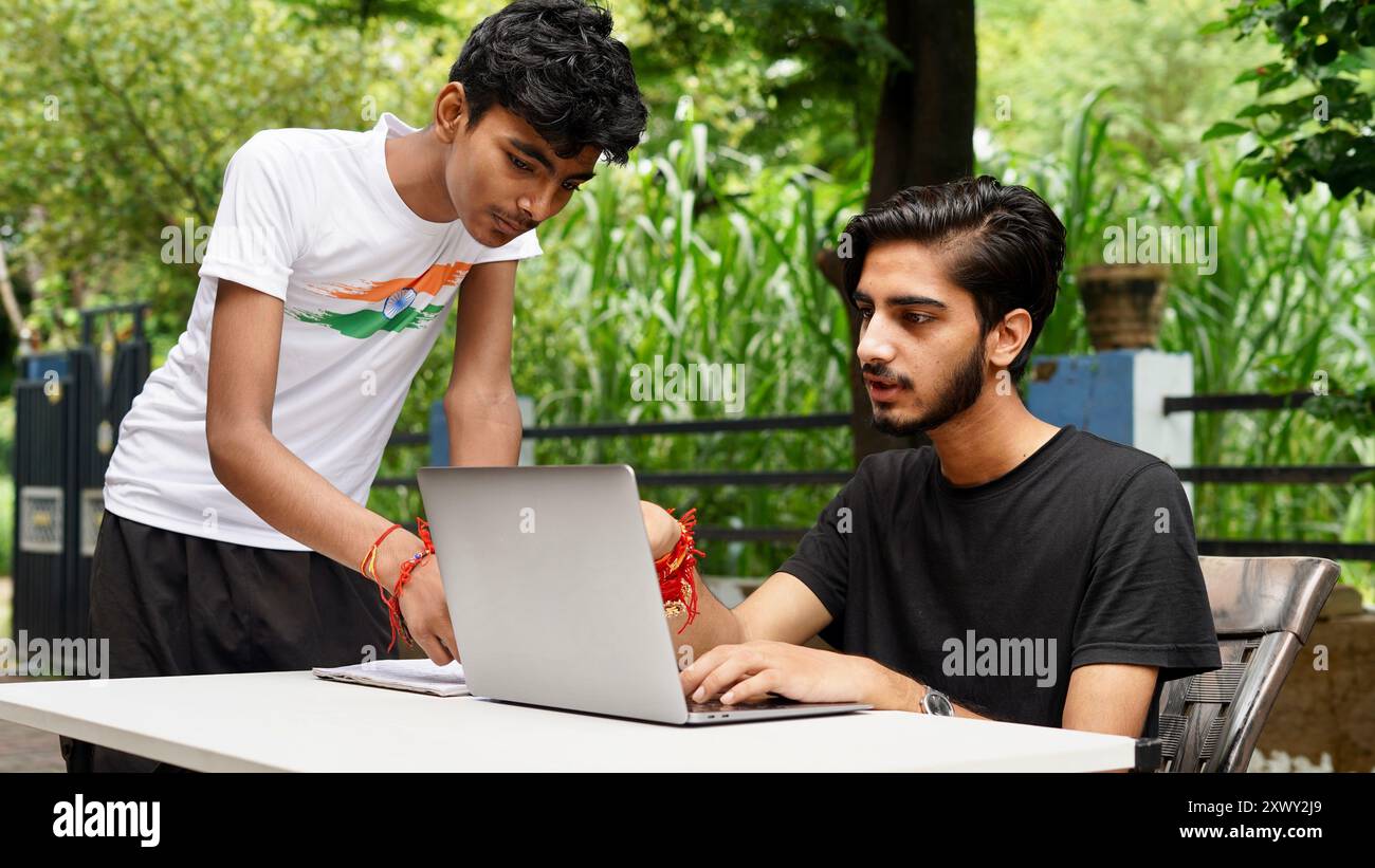 Indian village students learning online with laptop and doing homework ...