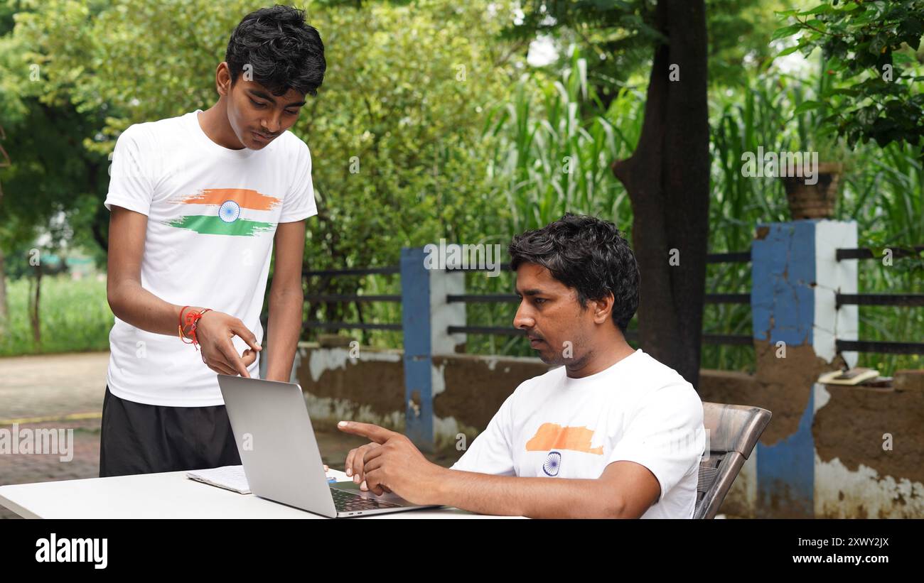 Indian village students learning online with laptop and doing homework ...