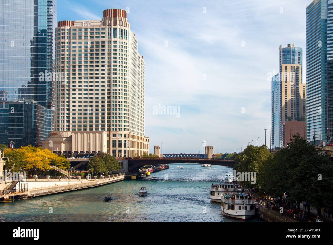 The tourboats on Chicago river and the skyline with modern architecture ...