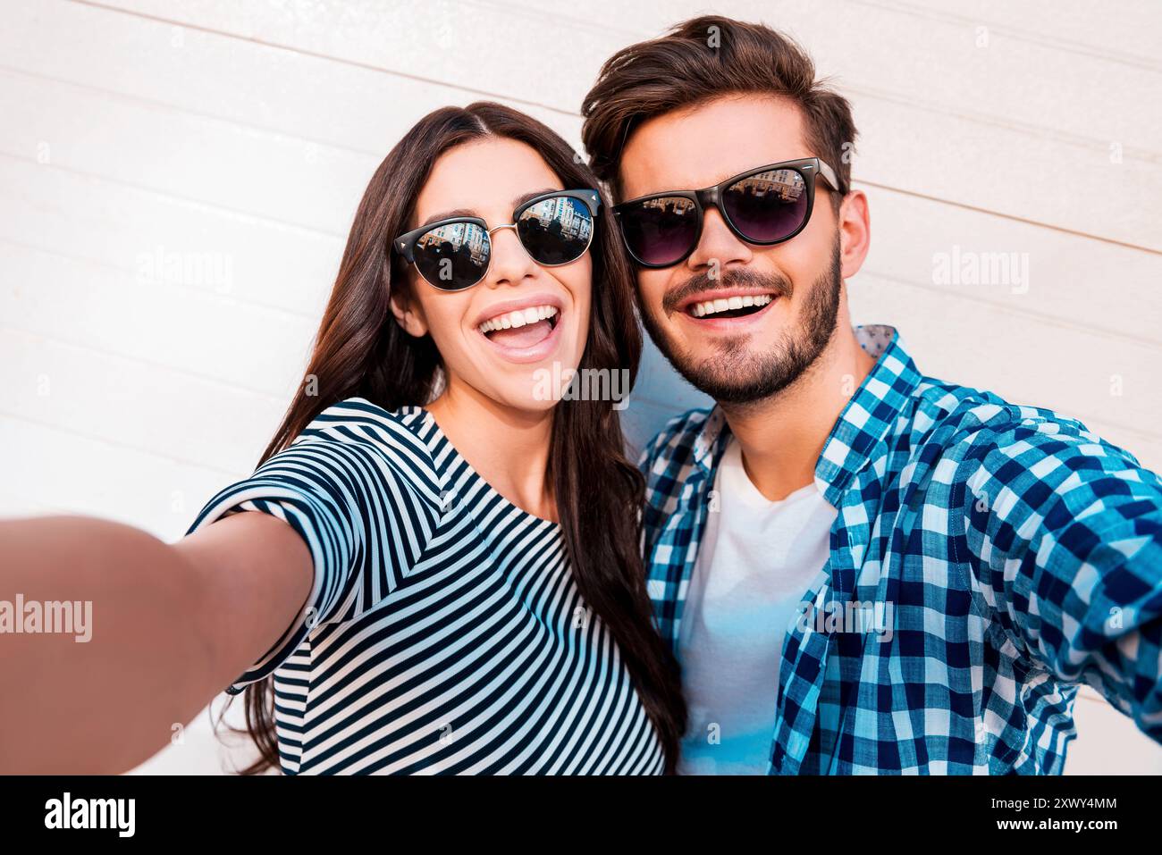 Capturing bright moments. Joyful young loving couple making selfie on ...