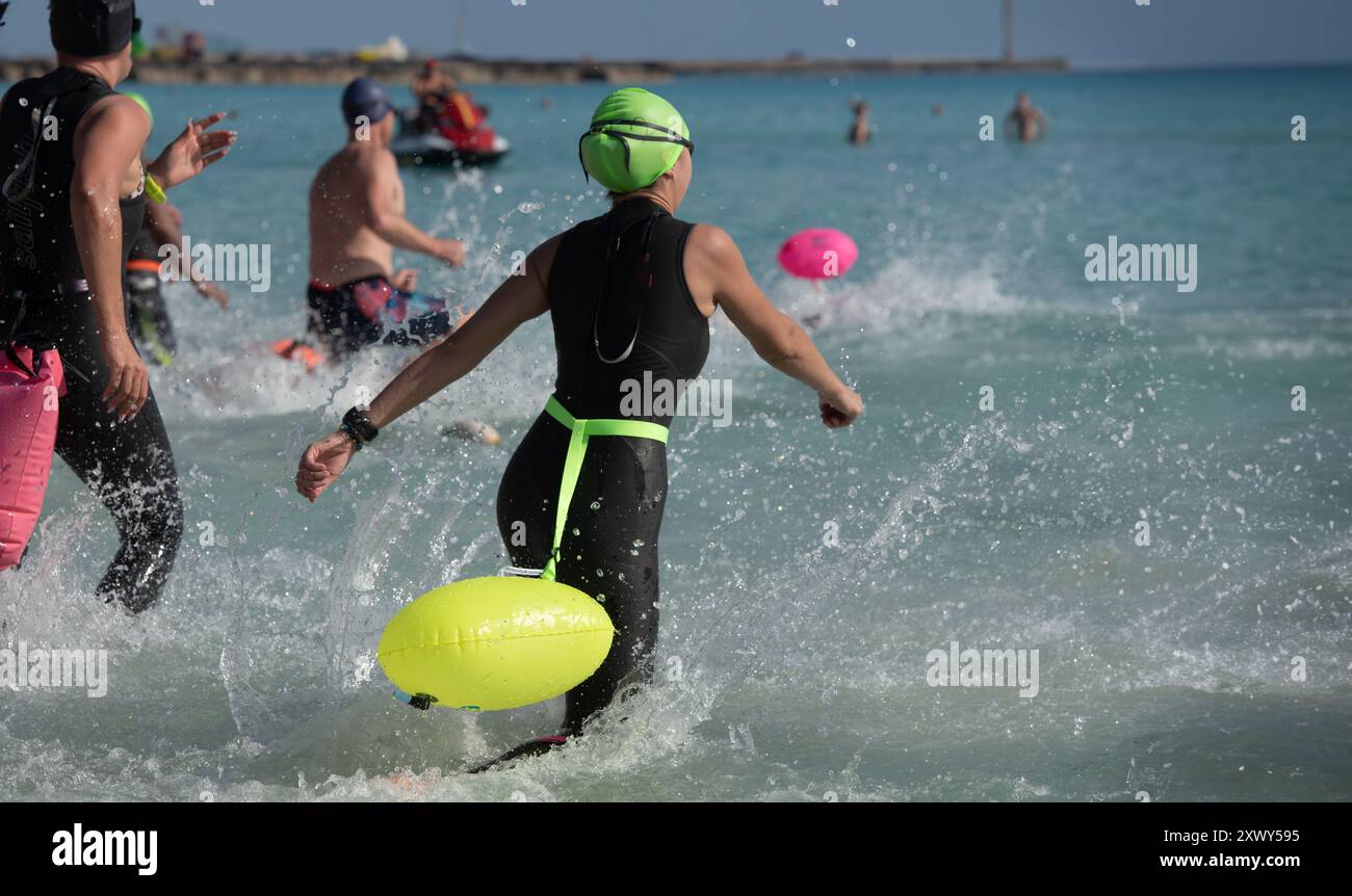 Athletes running in the sea to swim free style. Swimming race ...