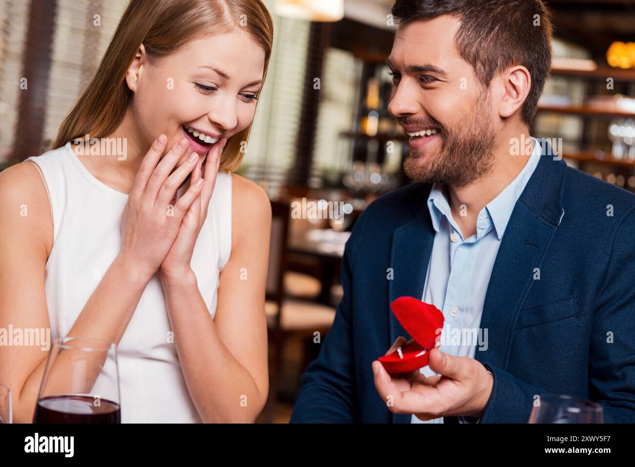 Will you marry me? Handsome young man making a proposal while giving an ...