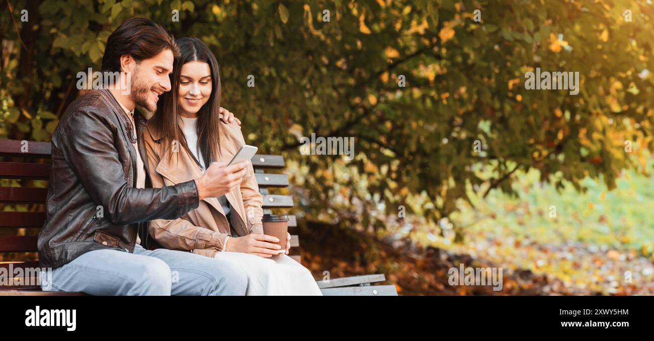 Cheerful guy showing his girlfriend new mobile app Stock Photo - Alamy