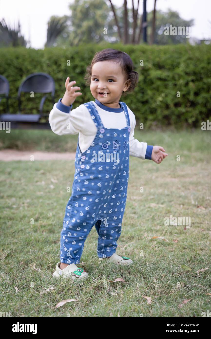 cute toddler trying to walk at park green grass from different angle ...