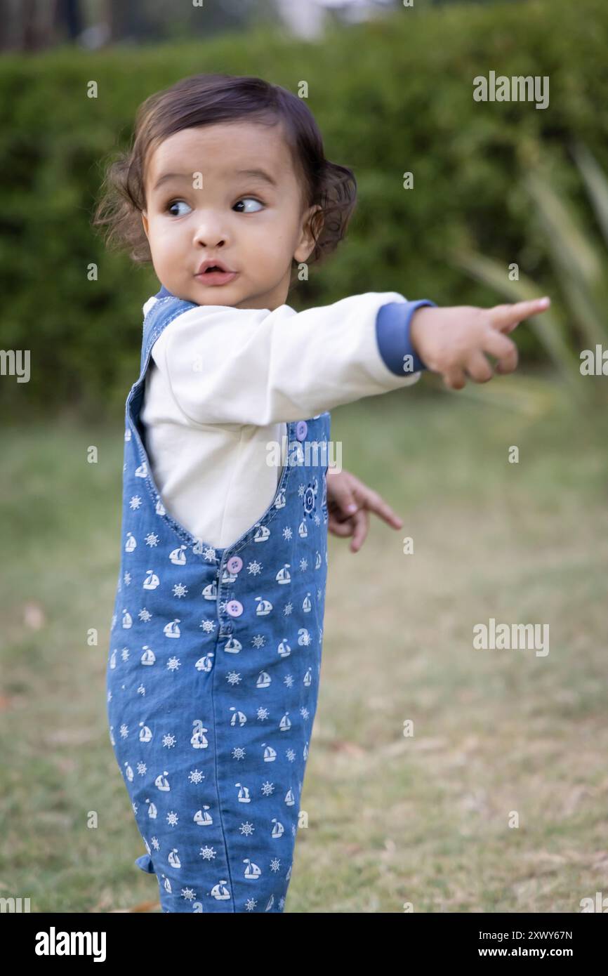 cute toddler trying to walk at park green grass from different angle ...