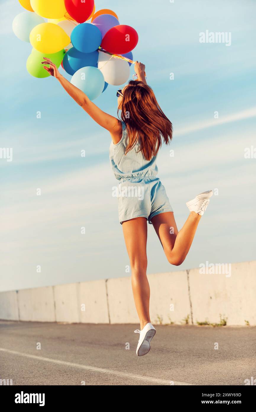 Women only rear view happy arms in air hi-res stock photography and ...