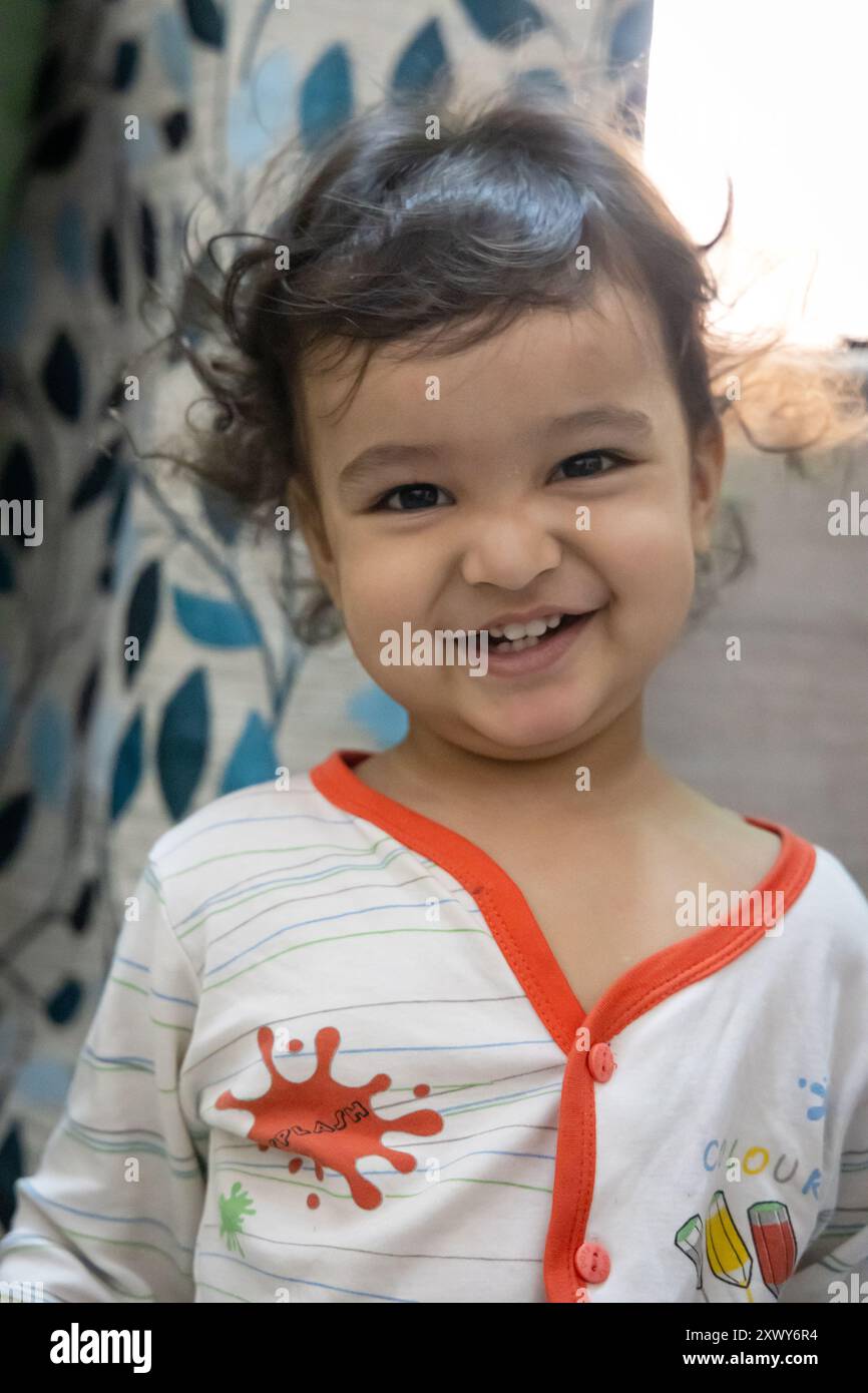smiling kid innocent facial expression at indoor at night Stock Photo ...