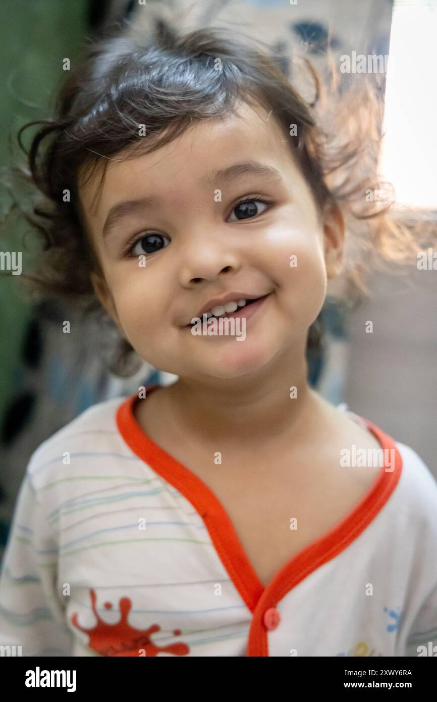 smiling kid innocent facial expression at indoor at night Stock Photo ...