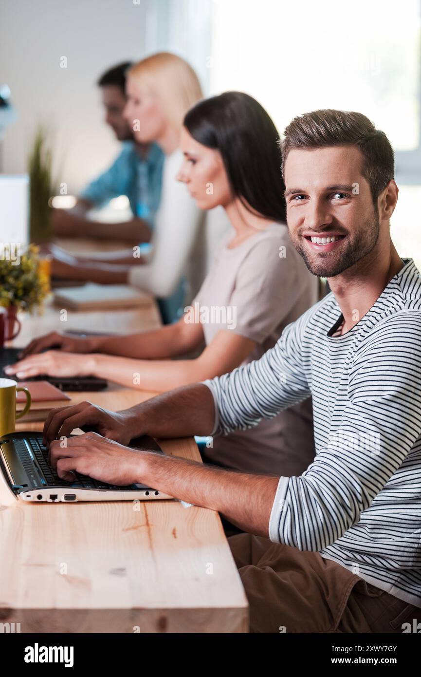 Enjoying his creative work. Top view of group of cheerful business ...