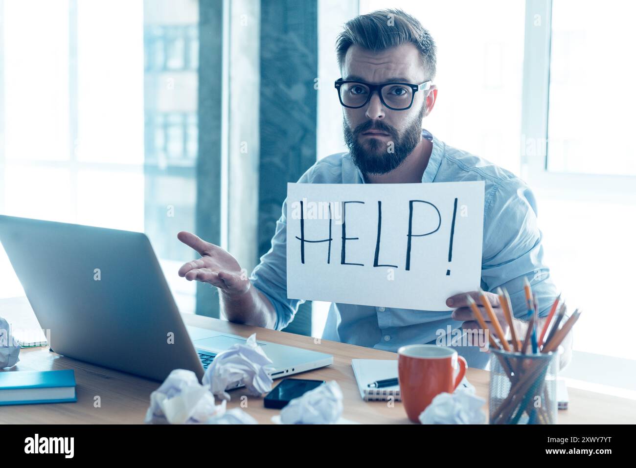 Asking for help. Frustrated young beard man holding piece of paper and ...