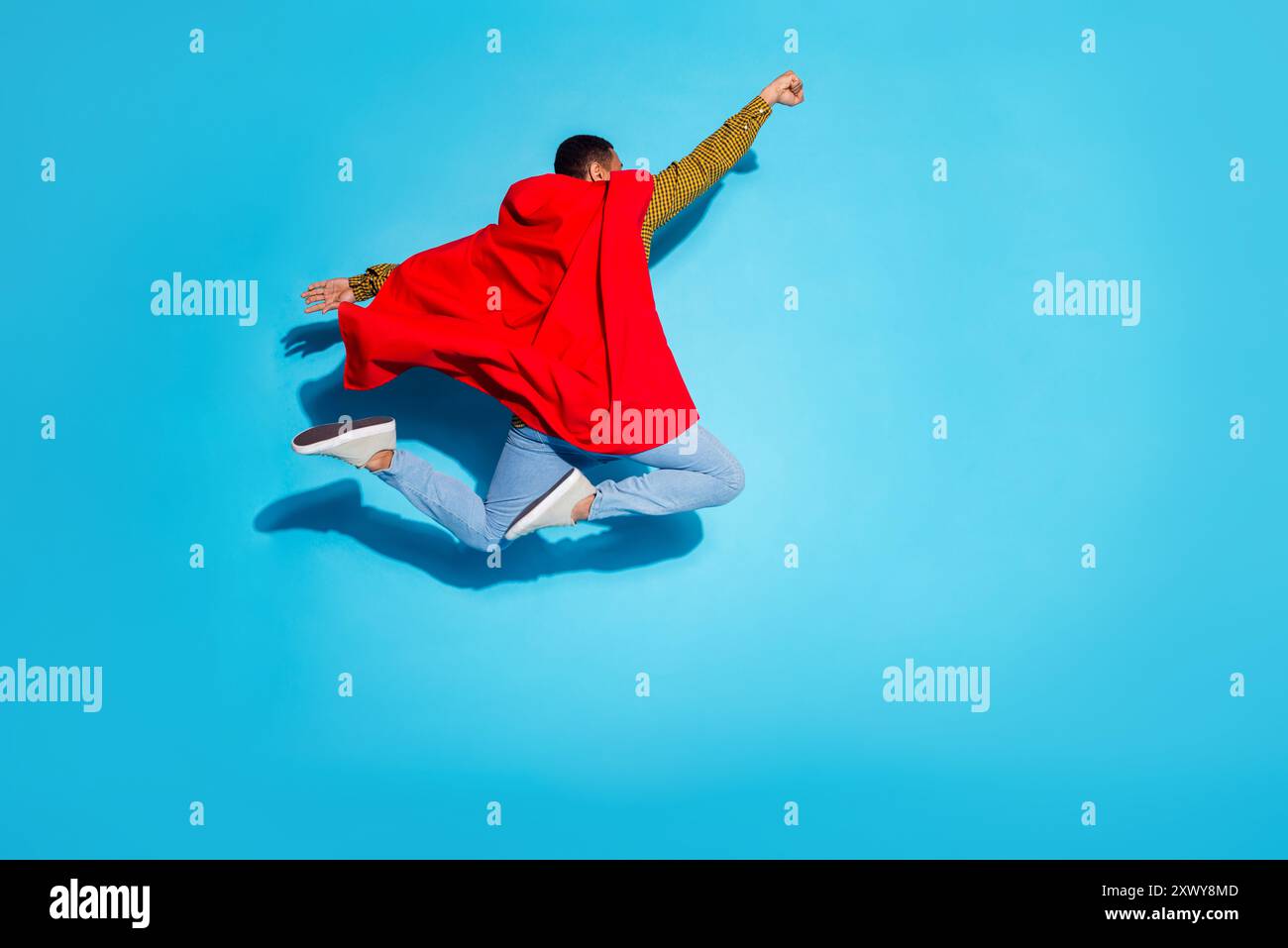 Full body photo of attractive young man flying superhero back behind ...