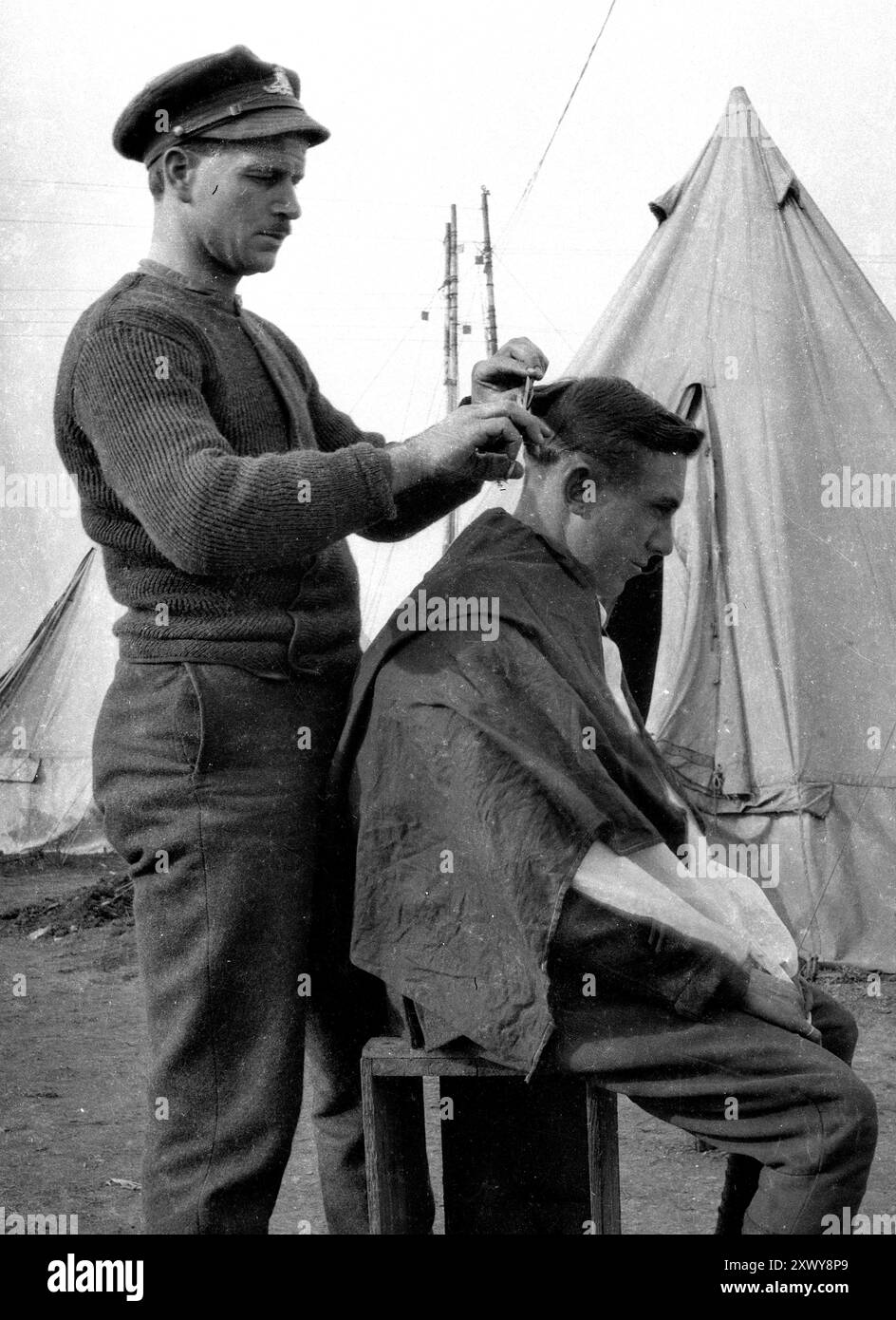 Royal Artillery soldier getting a military style hair cut in France 1915 during First World War ...