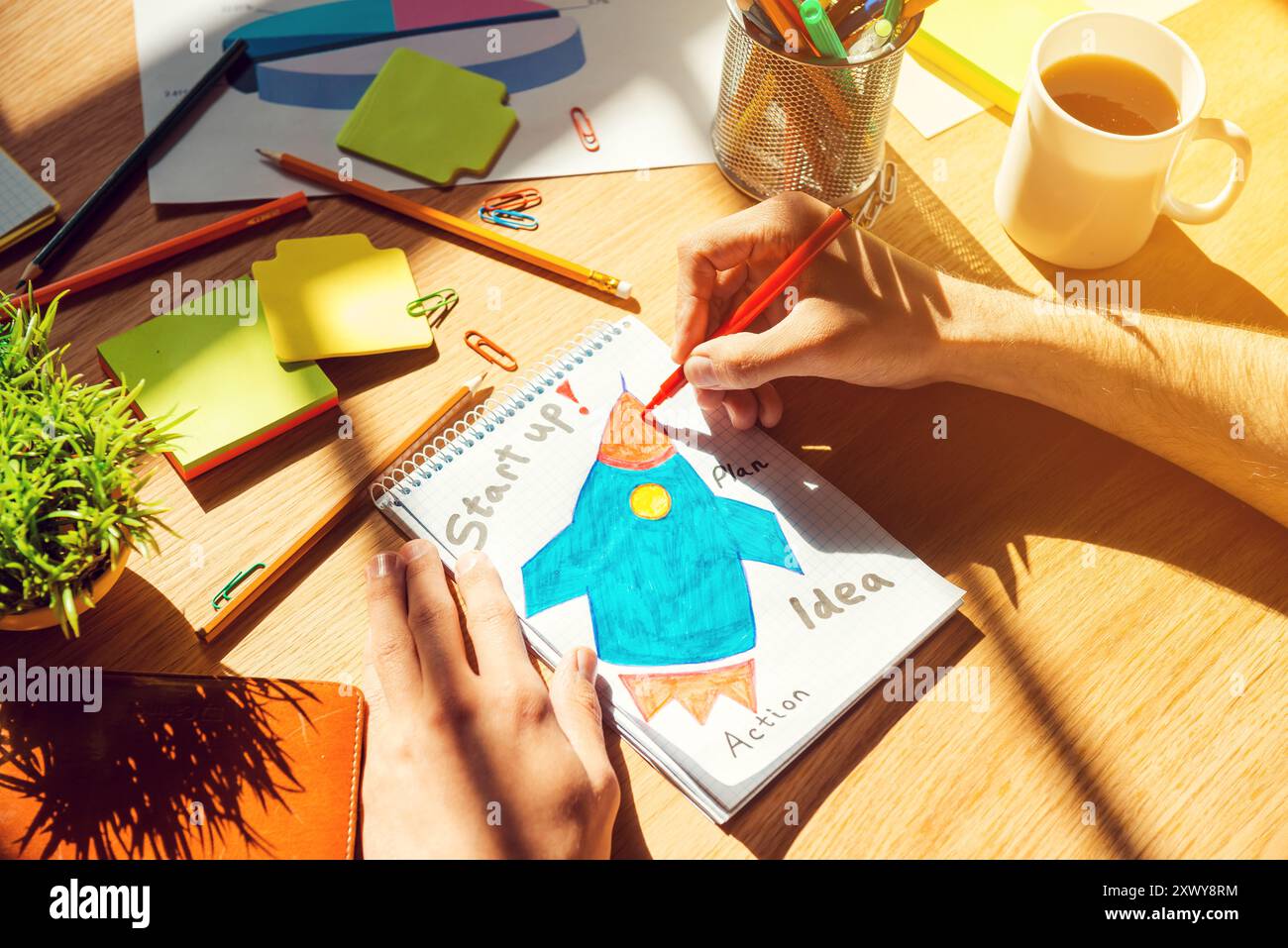 Just inspired. Close-up top view of man sketching on paper laying on ...