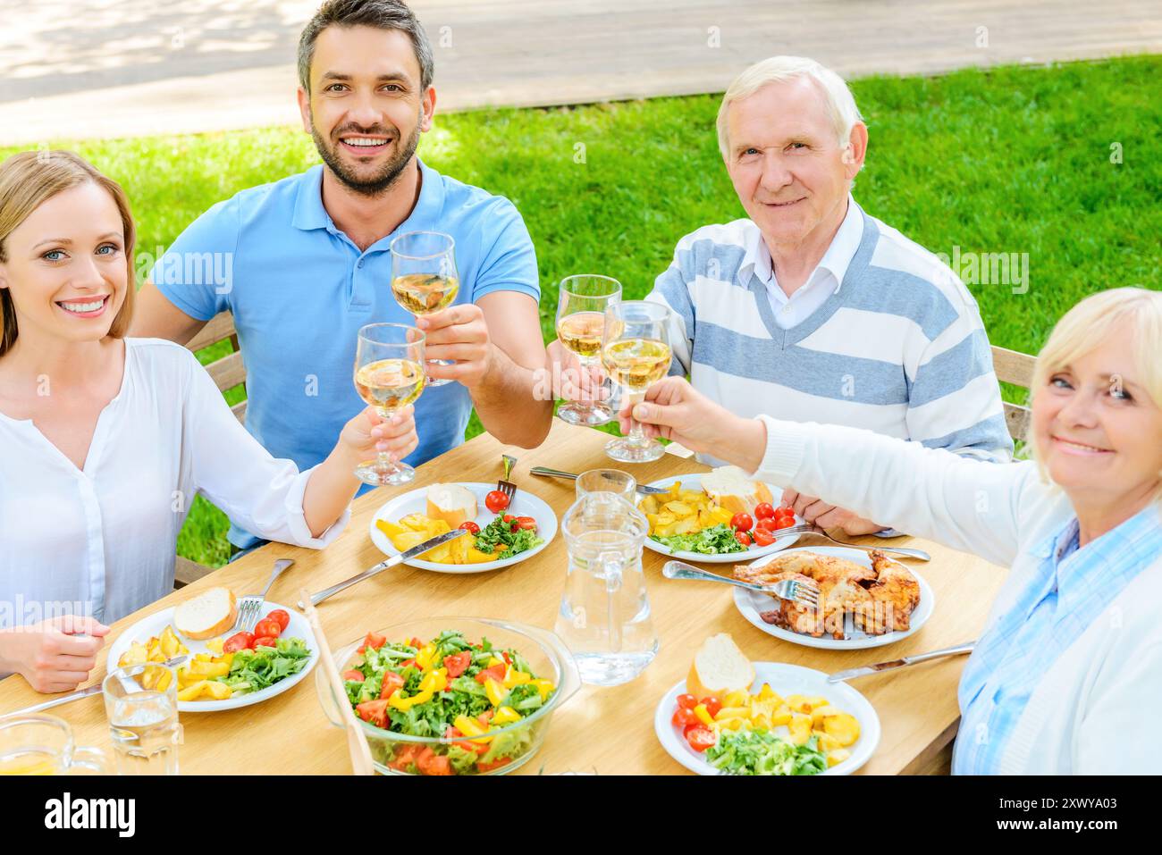 Family toasting with wine. Top view of happy family sitting at the ...