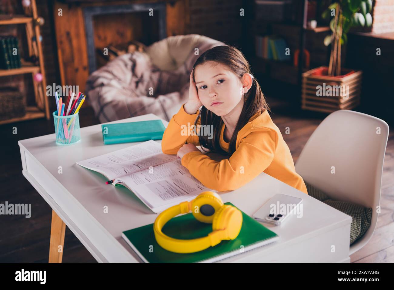 Photo portrait of cute small girl bored tired upset sit table do ...