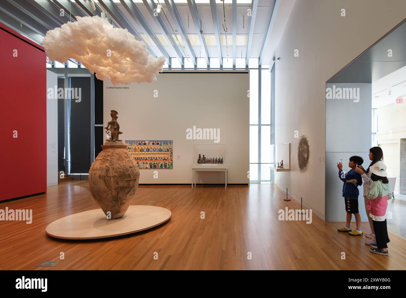 Family looking at When the Gods Speak, Heaven Listens, a sculpture by ...