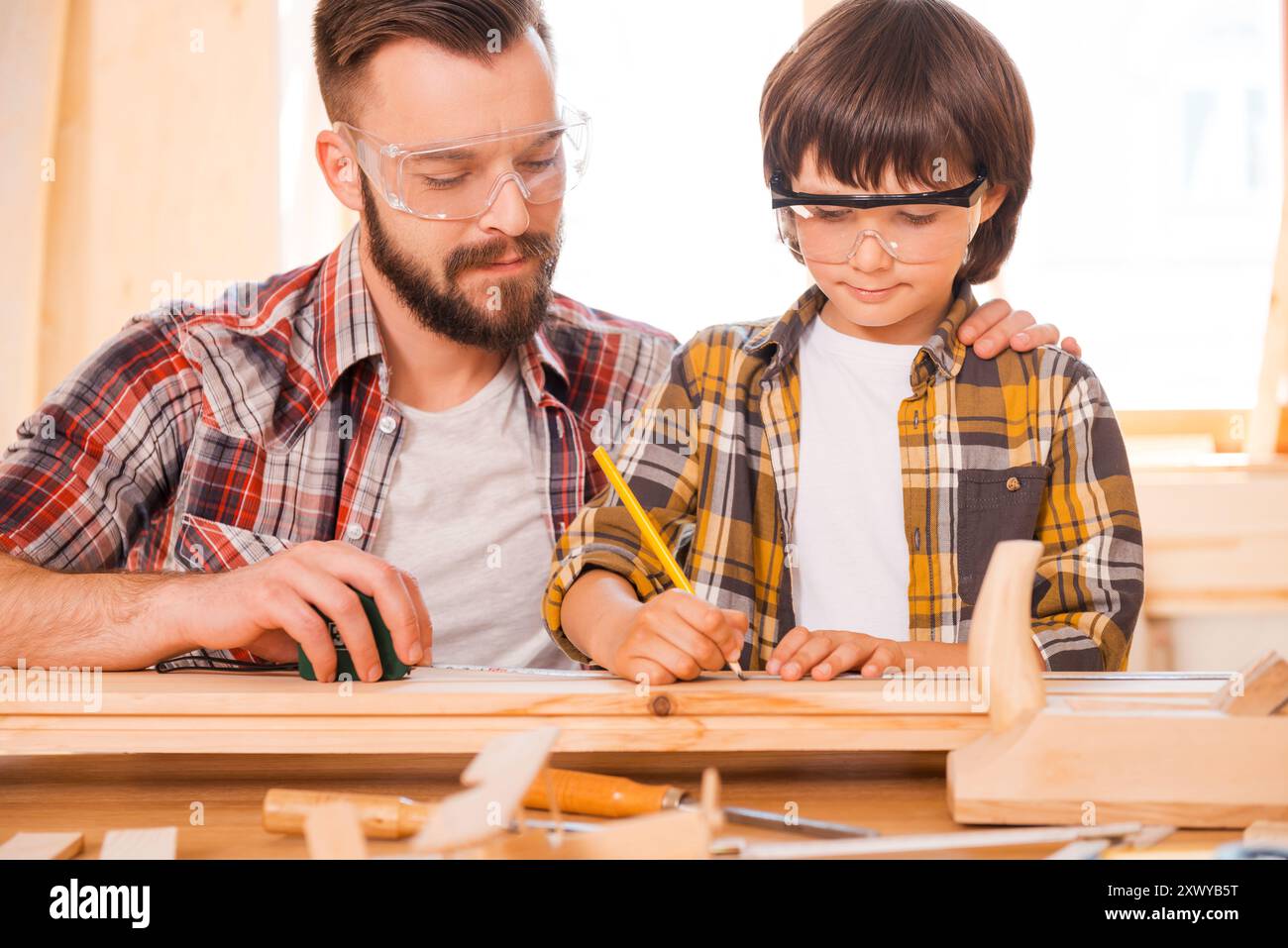 One day you will be a talented carpenter. Concentrated young male ...