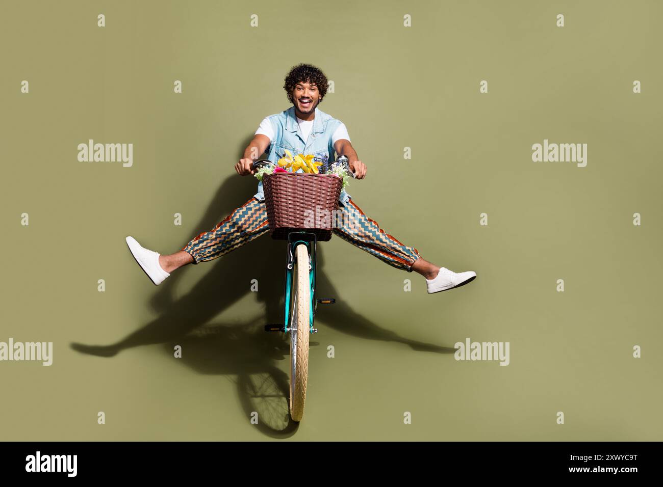 Full size photo of handsome young guy cycling have fun playful wear ...
