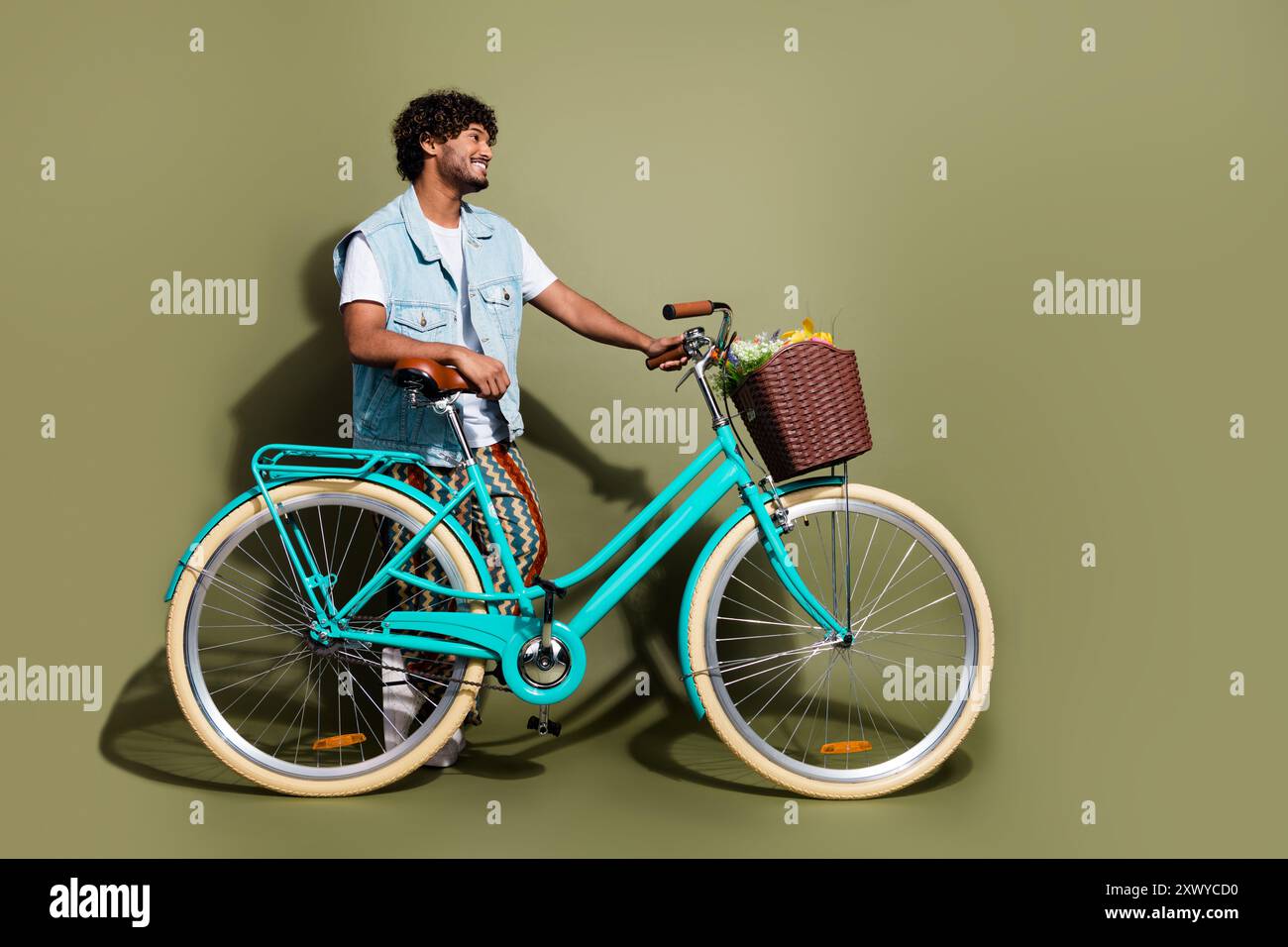 Full size photo of handsome young guy cycling travel wear trendy jeans ...