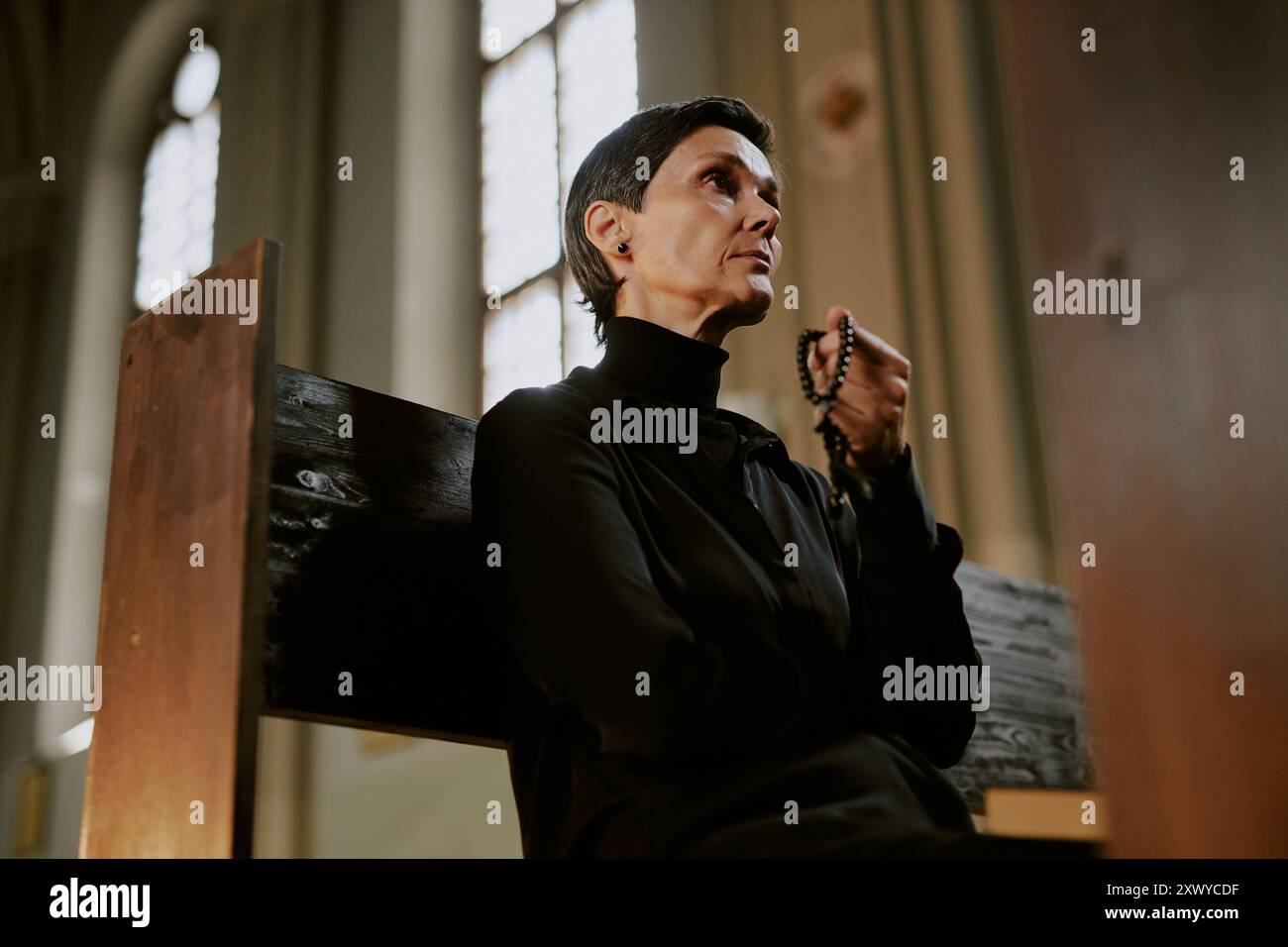 Mournful woman sitting on wooden hi-res stock photography and images ...