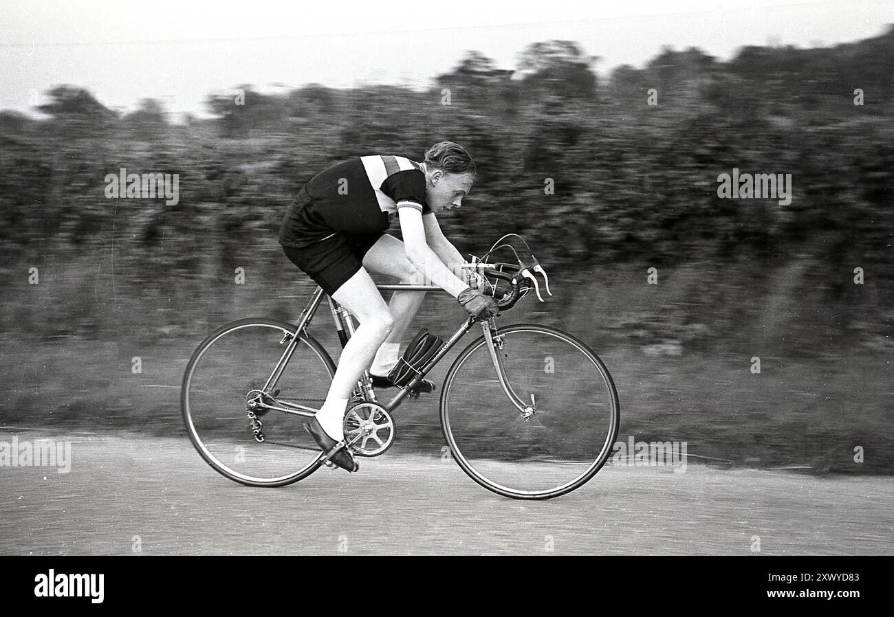 1960s, historical, male cyclist on road, spare rubber inner tube in ...