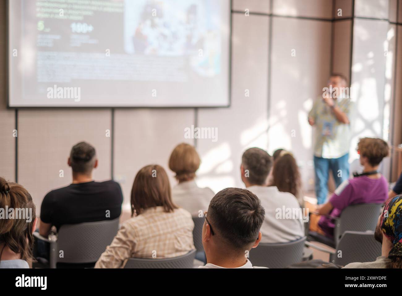 Group of people attentively listening to speaker during seminar in ...