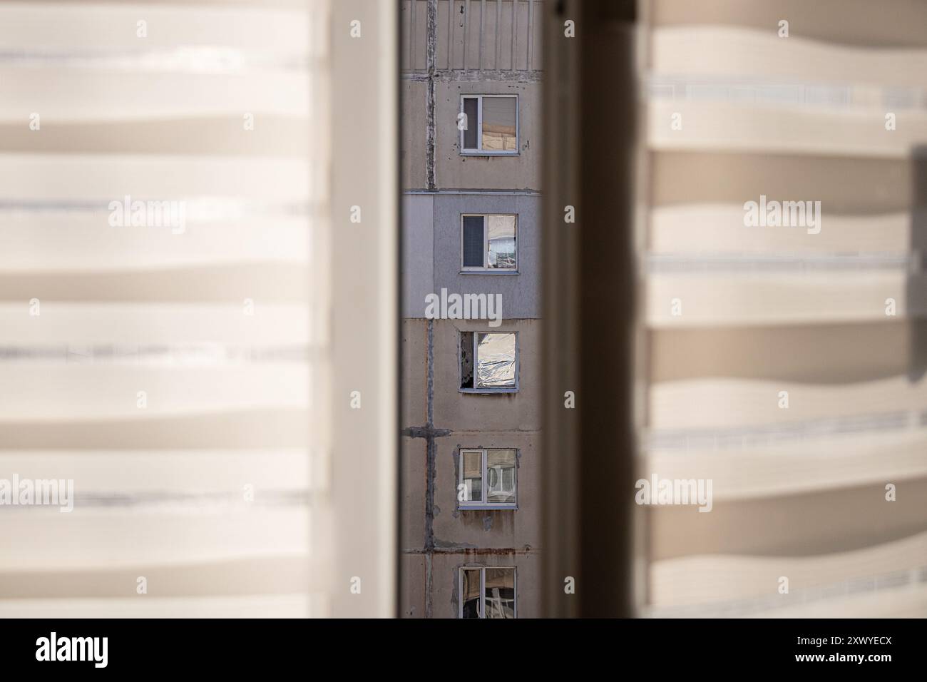 View from the apartment window of a neighboring multi-story panel house ...