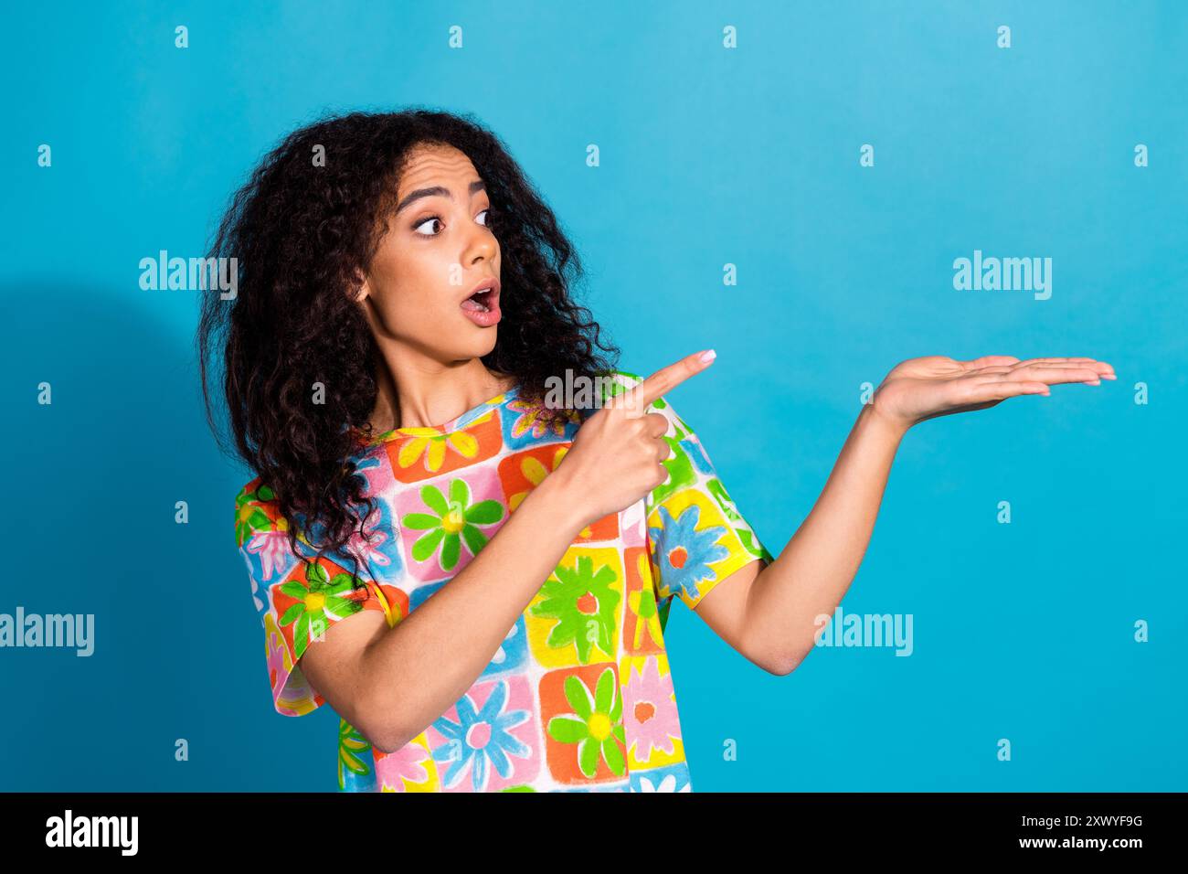Photo of cheerful impressed lady dressed flower print t-shirt pointing ...