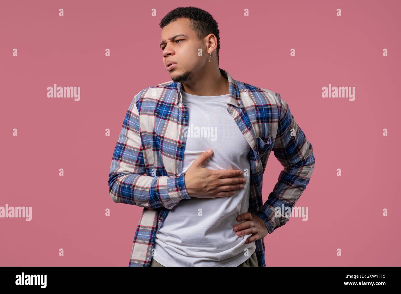 Man squeezing belly with hands because of abdominal pain. Adult guy ...