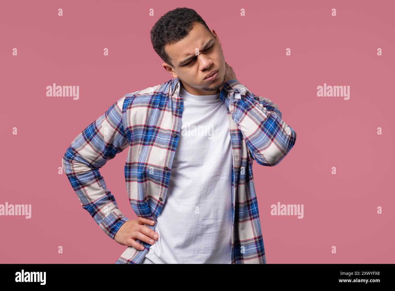 Tired african american man feeling pain in neck joint, massaging ...