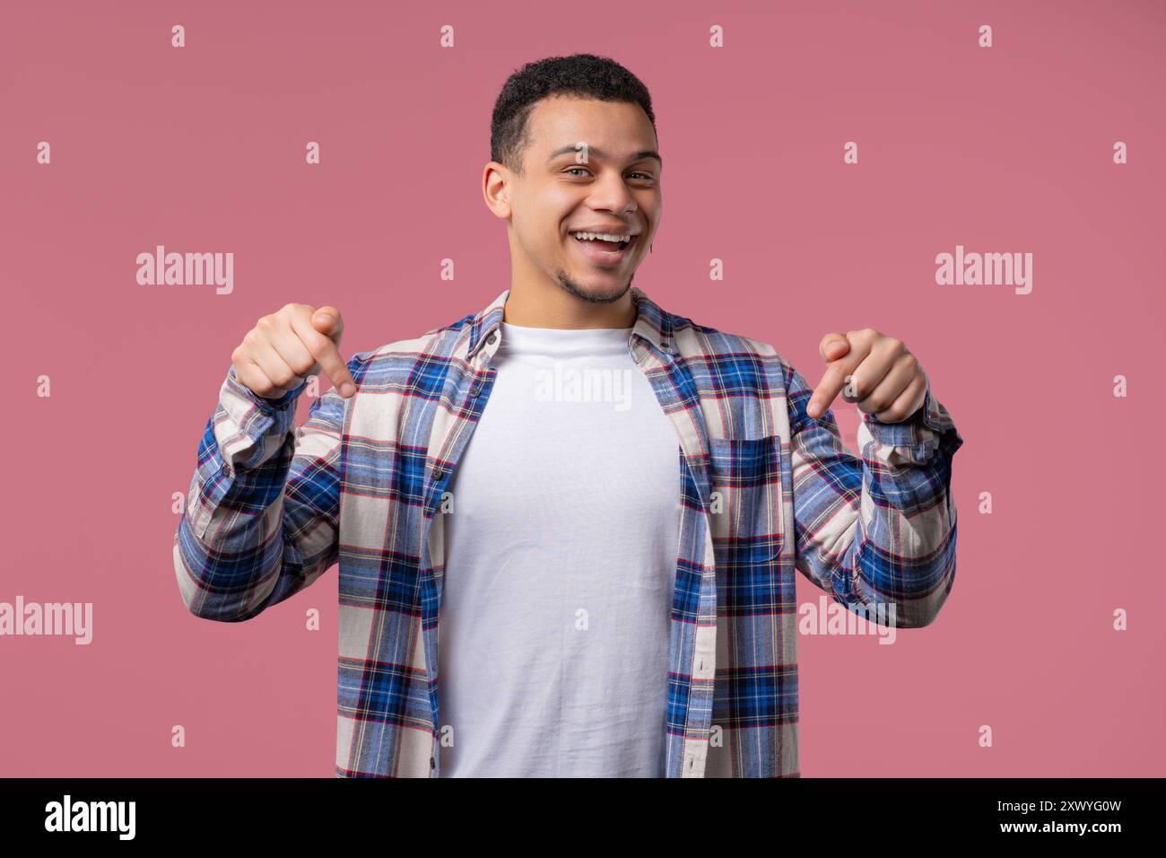 Blogger man pointing down to advertising area. Pink background. Click ...