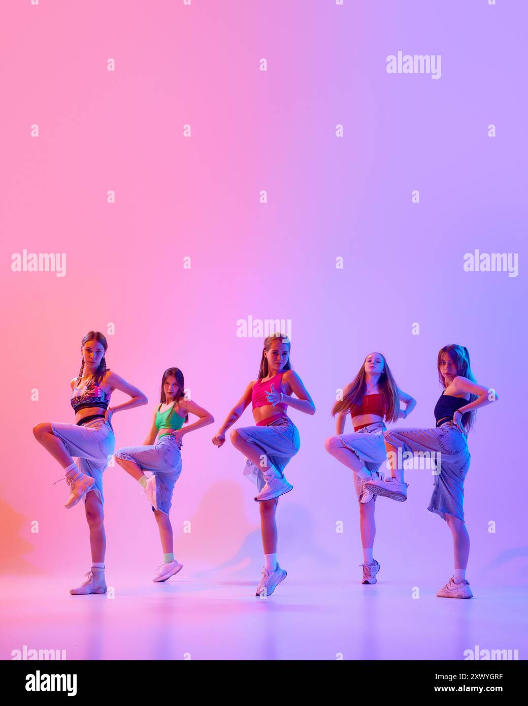 Poster. Dynamic portrait of talented young girls dancing in motion in ...